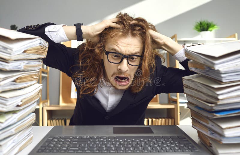 Funny Man Sitting at Office Desk with Computer Stressed by Crazy Load ...
