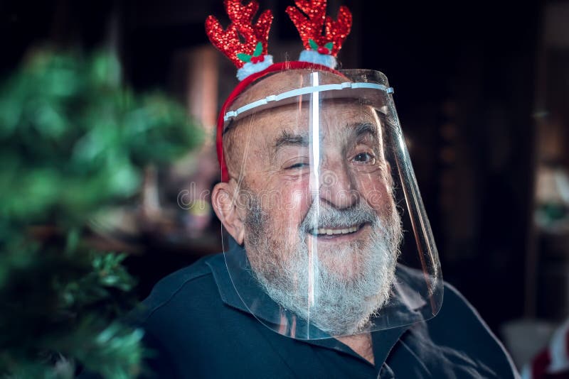 Senior Man Wearing a Protective Visor and Santa Claus Suit Stock Photo ...
