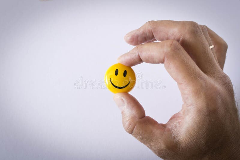 Funny Plastic Smiley Face in a Human Hand. the Concept of a Positive ...