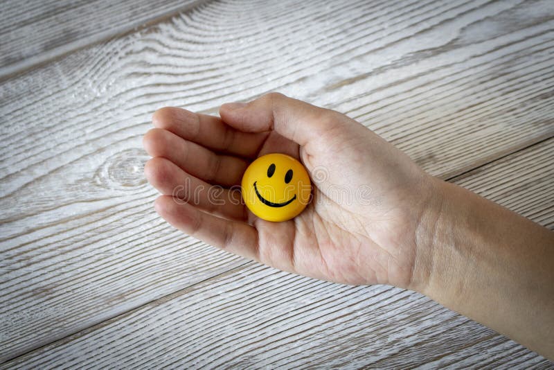 Funny Plastic Smiley Face in a Human Hand. the Concept of a Positive ...
