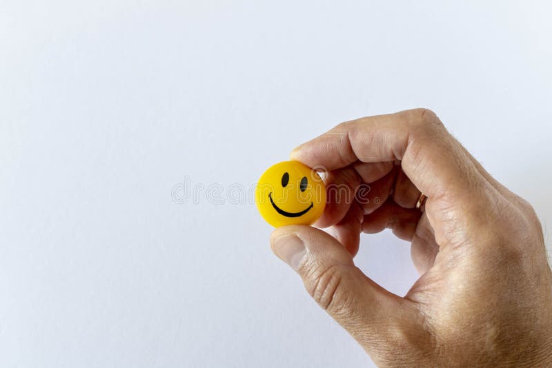 Funny Plastic Smiley Face in a Human Hand. the Concept of a Positive ...