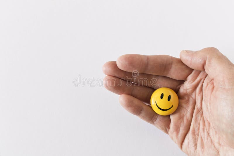Funny Plastic Smiley Face in a Human Hand. the Concept of a Positive ...