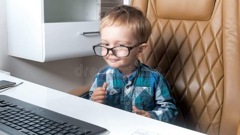Funny Portrait of Little Boy Wearing Eyeglasses Working in Office on ...