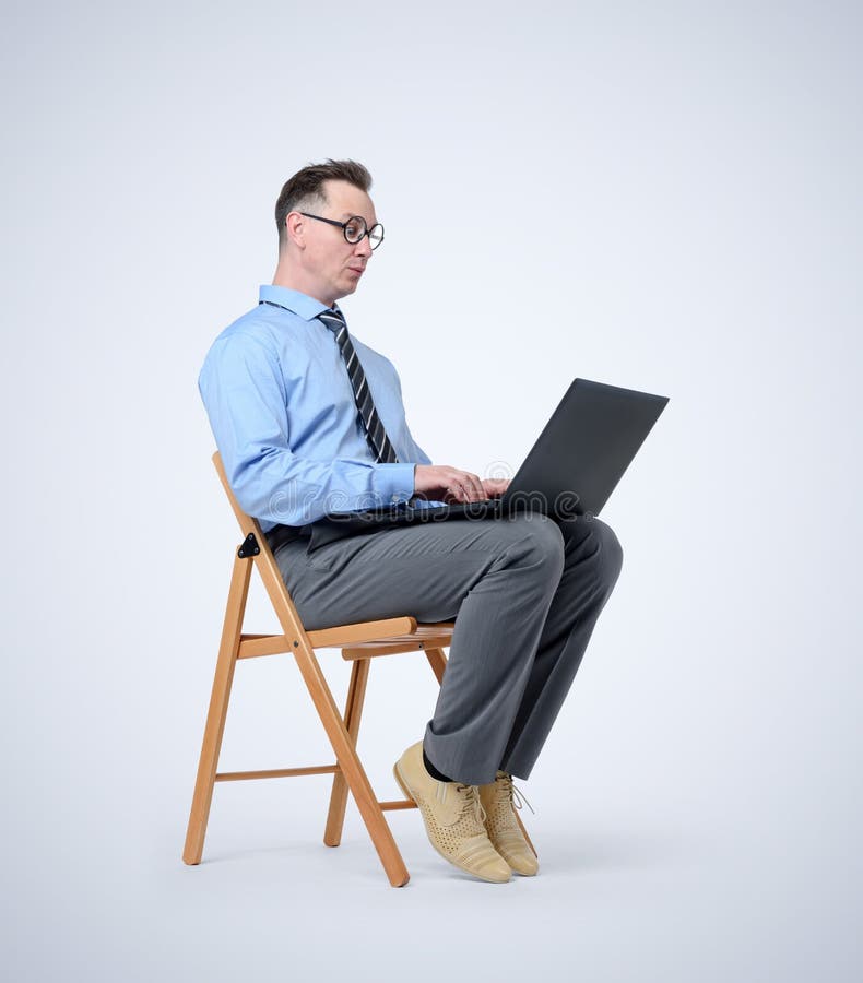Funny Programmer with a Laptop Sitting in a Chair on Background Stock ...