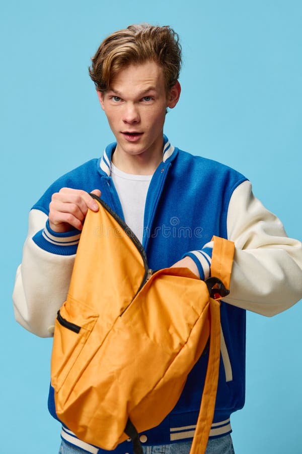 Funny, Red-haired Guy Student Makes a Funny Surprised Face Holding an ...