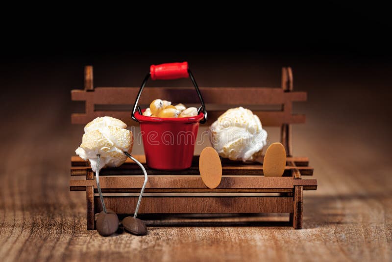 Funny Scene with Popcorn Figures on a Wooden Table, Sitting on a Bench ...