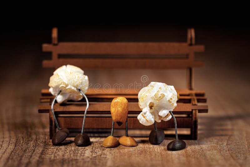 Funny Scene with Popcorn Figures on a Wooden Table, Sitting on a Bench ...