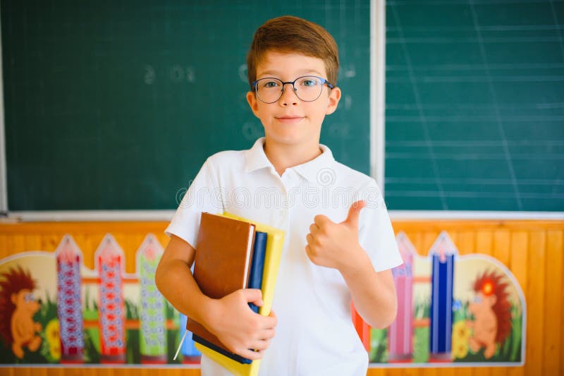 Funny Schoolboy Near the Green School Board in the Classroom ...