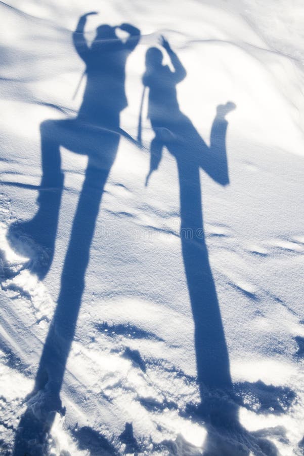 Funny Shadows of Two People Posing on White Snow Stock Photo - Image of ...