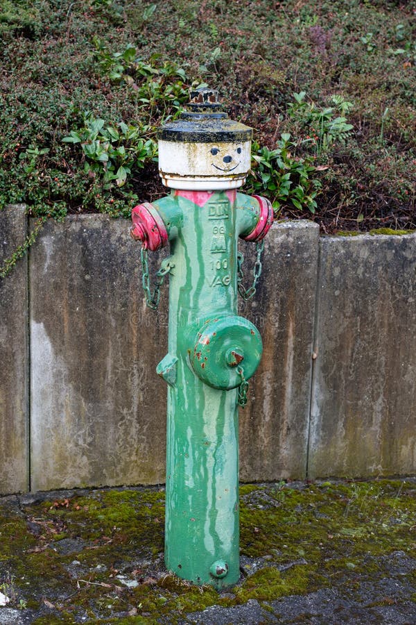 Green Fire Hydrant with Face Stock Image - Image of german, vintage ...