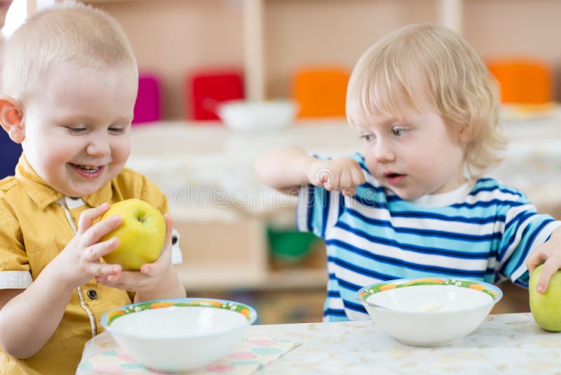 Funny Smiling Kid Eating Apple in Kindergarten Stock Photo - Image of ...