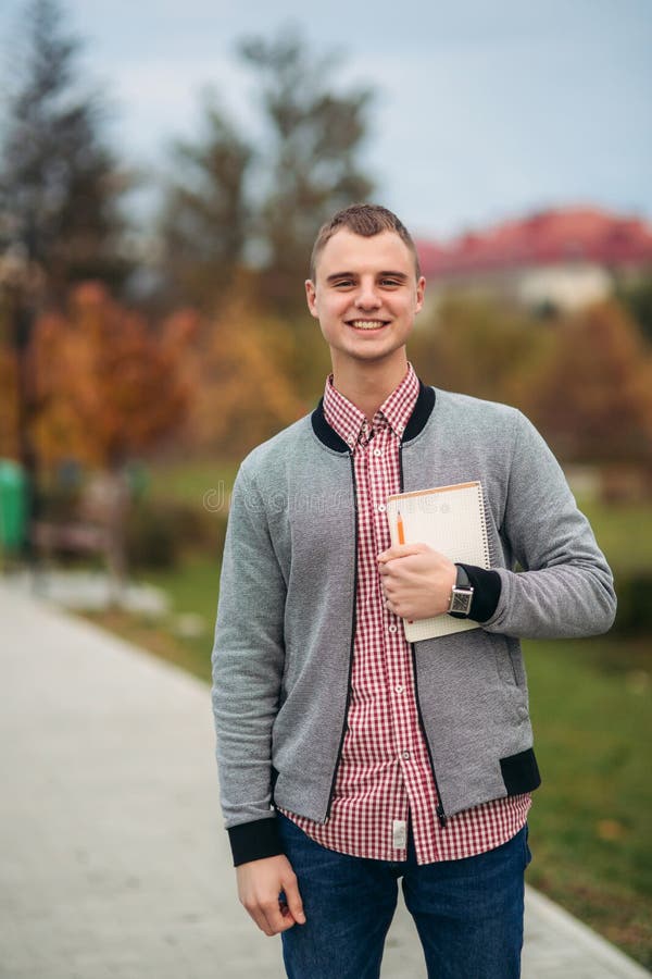 Funny Student with Notebook. Guy Stand in Park and Smile Stock Image ...