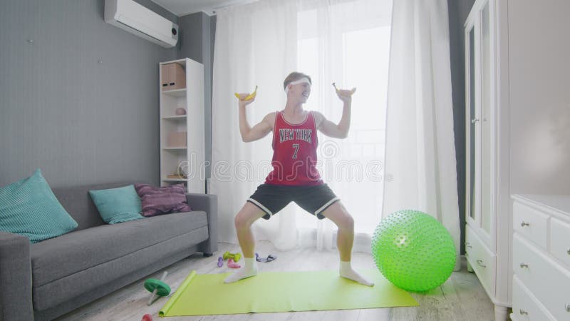 Funny Stupid-looking Guy Doing Workout Exercises on Biceps with Bananas ...