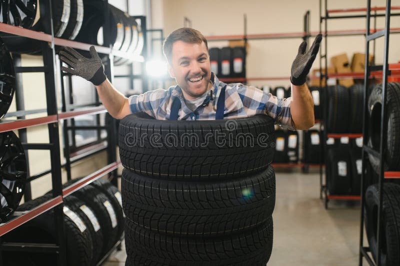 Funny Tire Shop Employee Having Fun at Work Stock Photo - Image of hold, store: 358876902