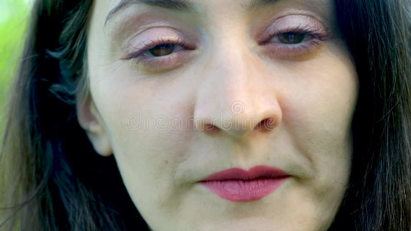 Funny Woman, Squinting and Clenching Her Teeth, Looks at the Camera ...