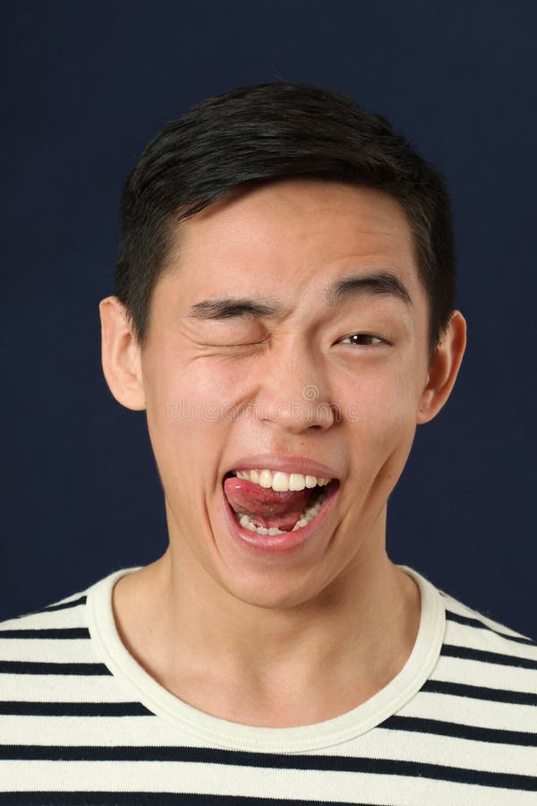 Funny Young Asian Man Making Face and Showing Tongue Stock Photo ...