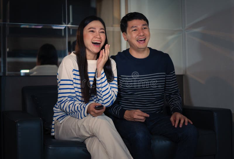 Funny Young Couple Watching TV on Sofa at Night Stock Image - Image of ...