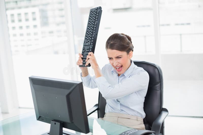 Furious Classy Brown Haired Businesswoman Throwing Her Keyboard on Her ...