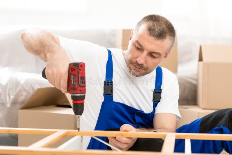 Furniture Assembler Assembling Cabinet Working Using Electric Drill