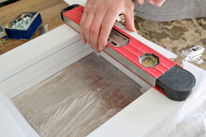 Furniture Assembly. Carpenter Using Building Level Stock Image - Image ...