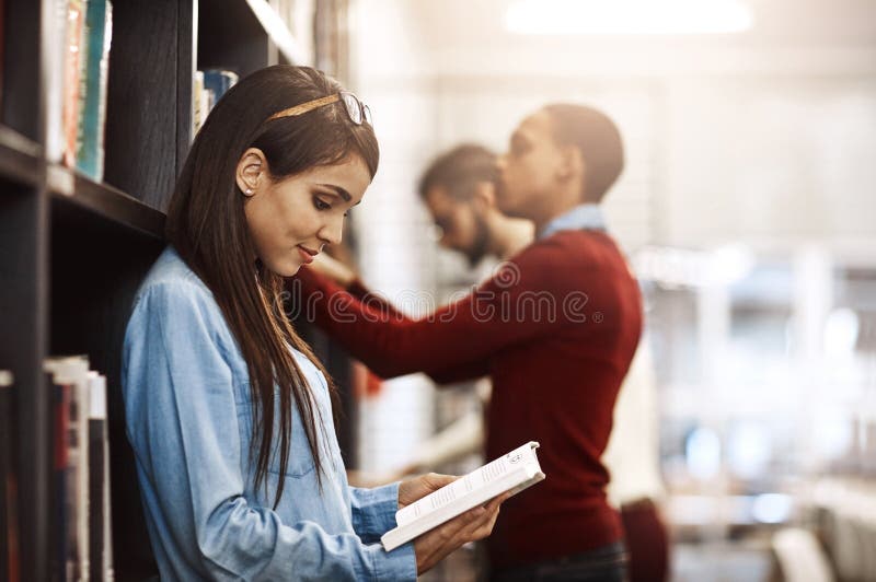 Furthering Her Knowledge for the Future. a University Student Reading a ...
