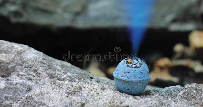 Smoke Bomb Burning on Forest Glade Breaking through Trees Stock Footage ...