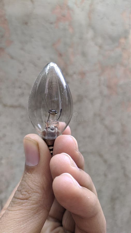 Small Sharp Glass Light Bulb in the Hand Stock Photo - Image of ...