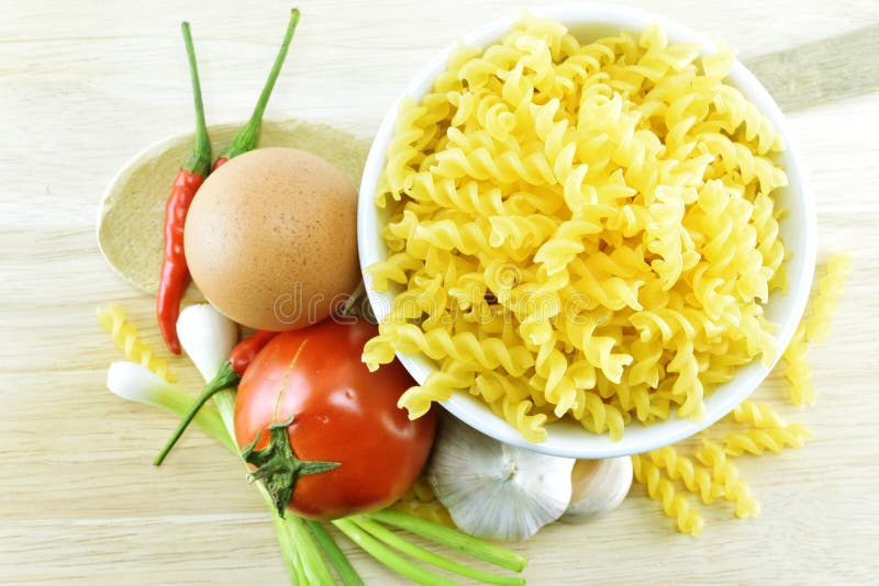 Fusilli, Garlic, Chilli, Onion, Egg and Tomato on Wooden Stock Photo ...