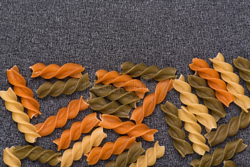 Fusilli Multi-colored Pasta on Grey Background. Ingredients of Italian ...