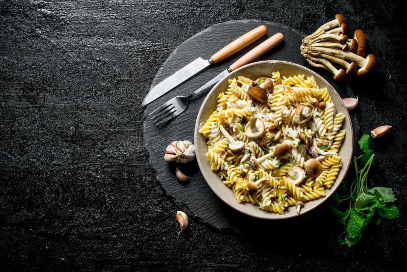 Fusilli Paste in Plate with Mushrooms, Garlic and Mint Leaves Stock ...