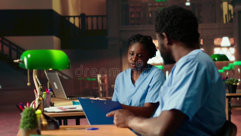 Future Nurses Studying Anatomy Class Notes in a University Library ...