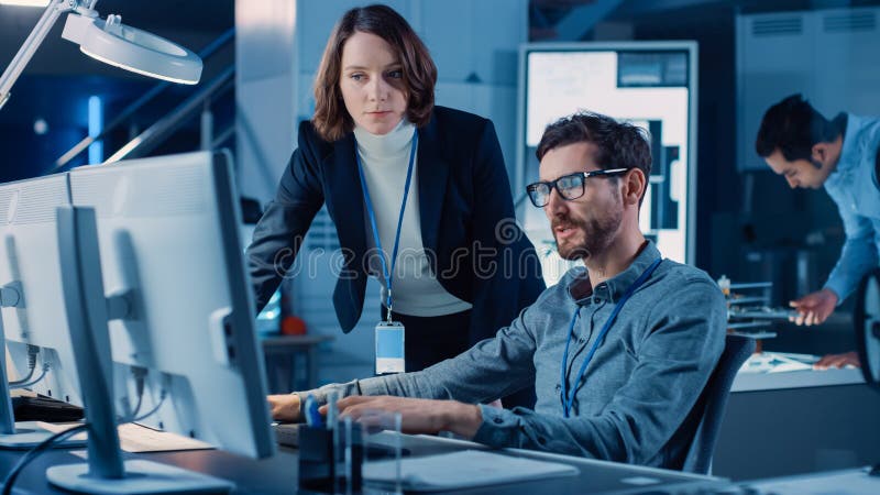 Futuristic Machine Engine Development Engineer Working on Computer at ...