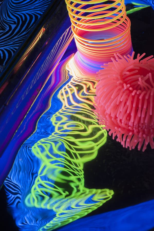 Fuzzy and Circular Objects are Lit with Fluorescent Colors Against a ...