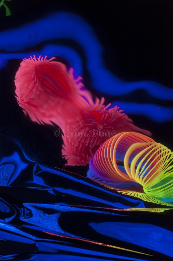 Fuzzy and Circular Objects are Lit with Fluorescent Colors Against a ...