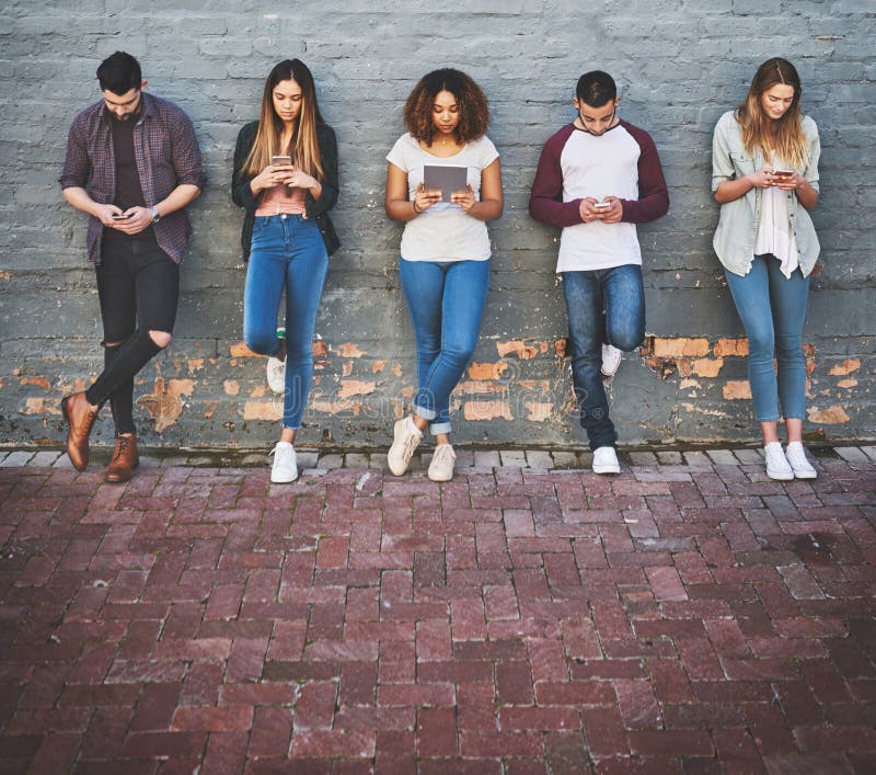 The 4g Generation. a Group of Young People Using Their Wireless Devices ...