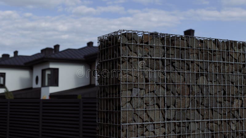 Gabion Fence. Posts Full of Stones with Sections from Wooden Planks ...