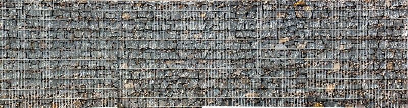 Gabion, a Stone Wall with a Metal Grid of Gray Granite Texture Stock ...