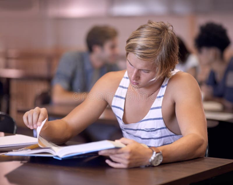 Gaining Knowledge. a Young Man Studying for Exams in the Library. Stock ...
