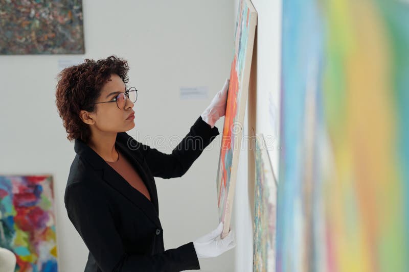 Gallery Owner Hanging Paintings on the Wall Stock Image - Image of ...