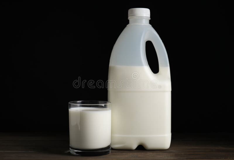 Gallon Bottle and Glass of Milk on Wooden Table Stock Image - Image of ...