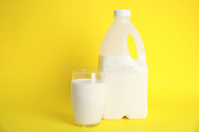 Gallon Bottle and Glass of Milk on Yellow Background Stock Image ...