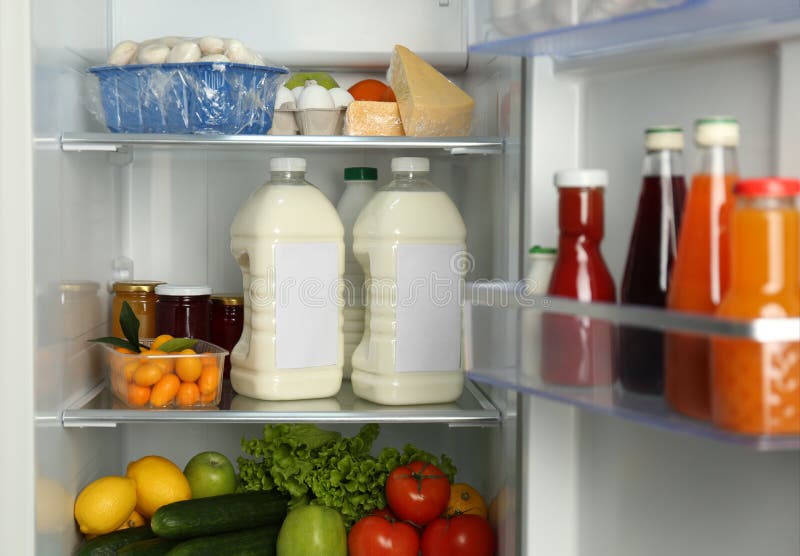 Gallons of Milk and Different Products in Refrigerator, Closeup Stock ...