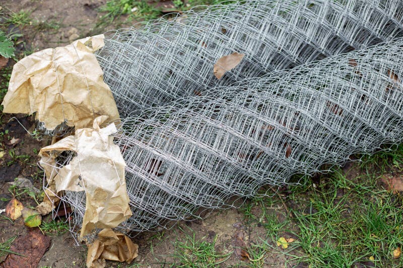 Galvanized Metal Mesh Netting in Rolls on the Grass. Construction ...