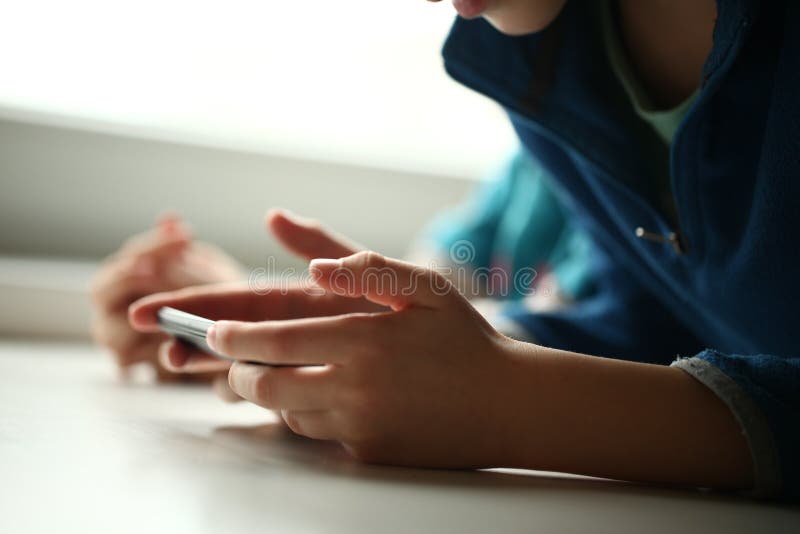 Game Addiction in Children Two Children Playing with a Smartphone while ...
