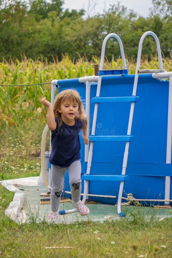 A game around the pool stock image. Image of grass, playing - 189058987