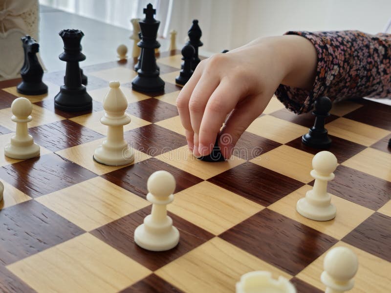 A Game on a Chess Board with Black and White Pieces Stock Photo - Image ...