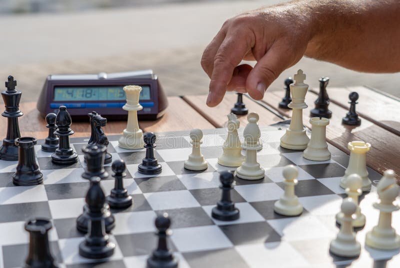 A Game of Chess, a Man`s Hand Rearranges a Chess Piece on a Chessboard ...