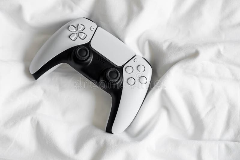Game Controller, Lying on White Sheets of Bed at Home. Stock Image ...
