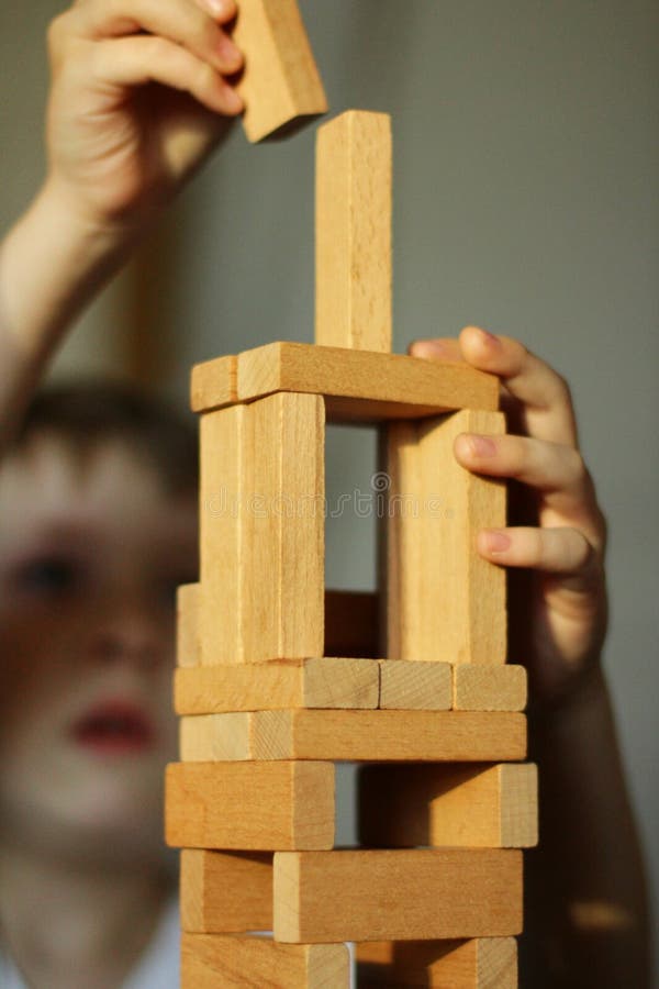 A Game with Wooden Bars. the Child Uses a Construction Kit for ...
