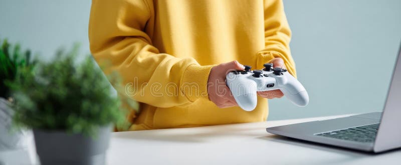 The Gamer Holding a White Controller in a Bright, Casual Workspace ...